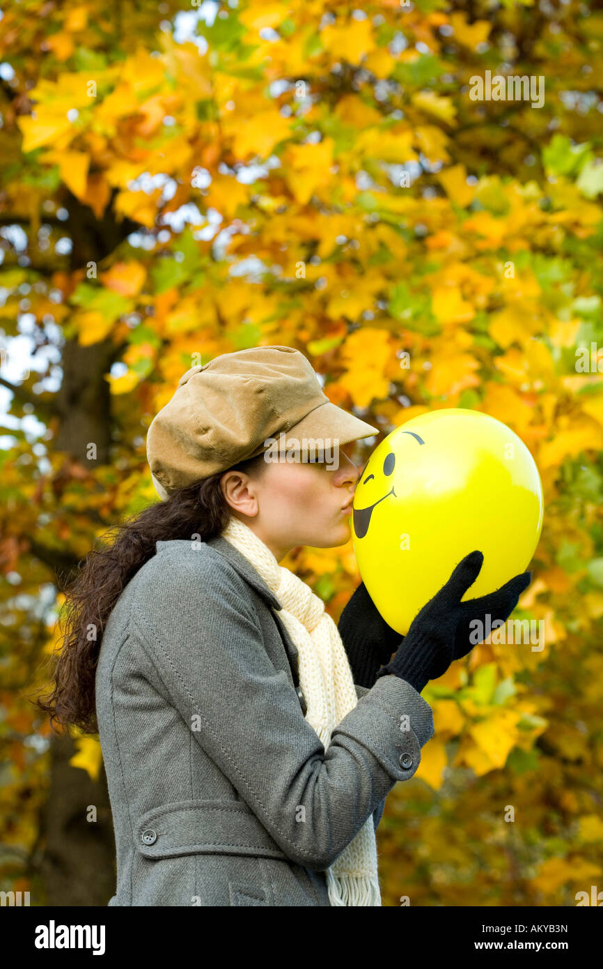 Woman is kissing a balloon Stock Photo - Alamy