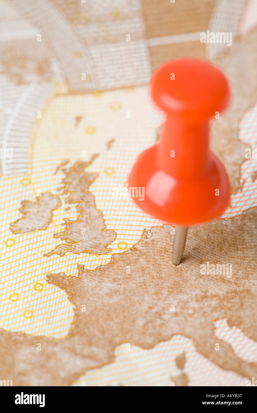 Fixing pin of a banknote on map showing Europe Stock Photo - Alamy