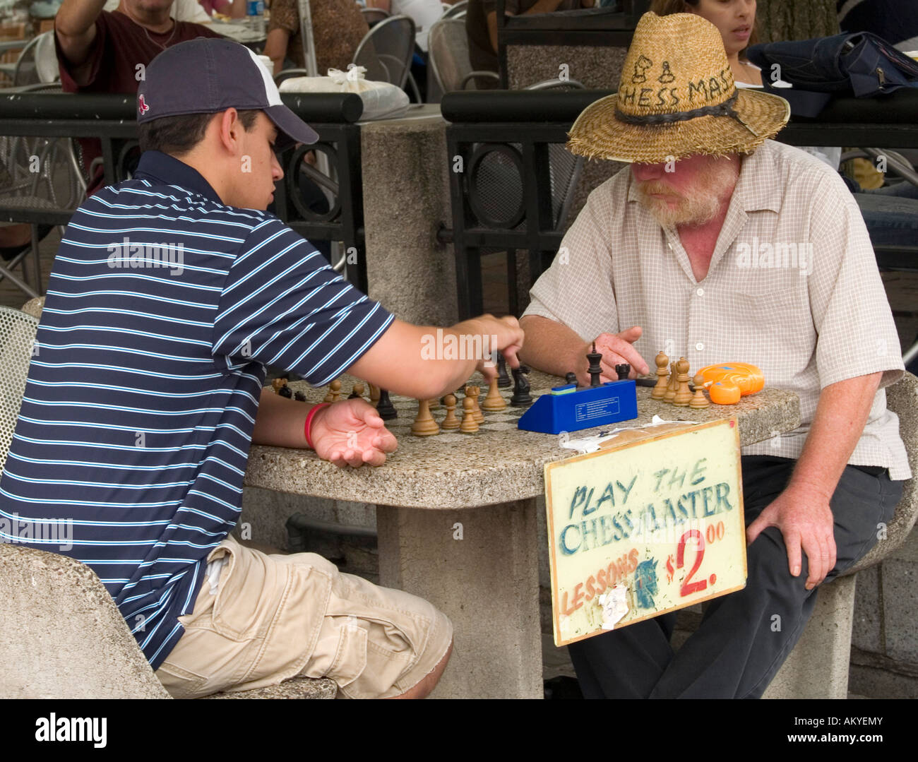 Two men play a game of chess, as the Chessmaster is challenged to a ...