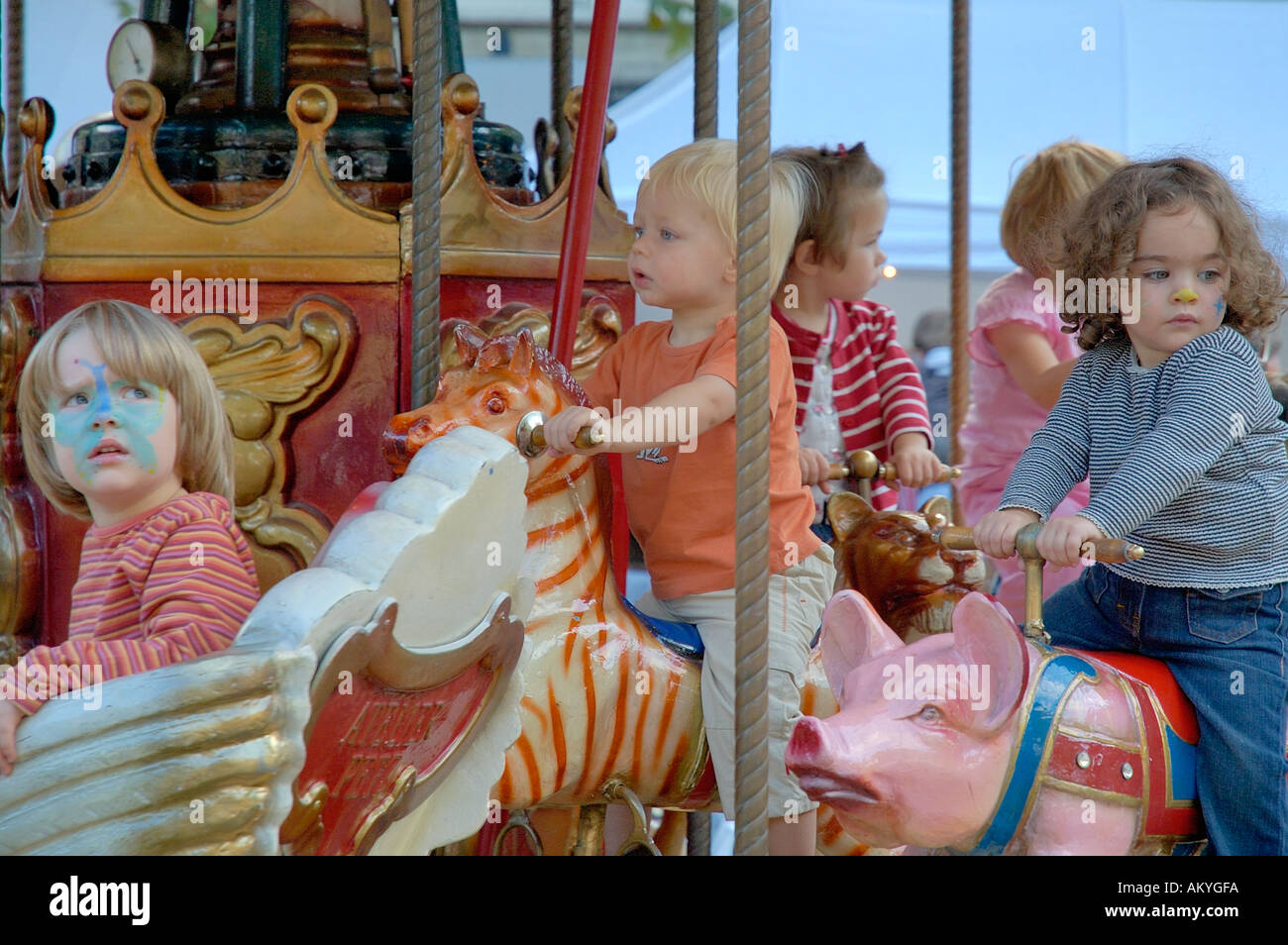 Kids playing on a beautiful antique merry go round Stock Photo - Alamy