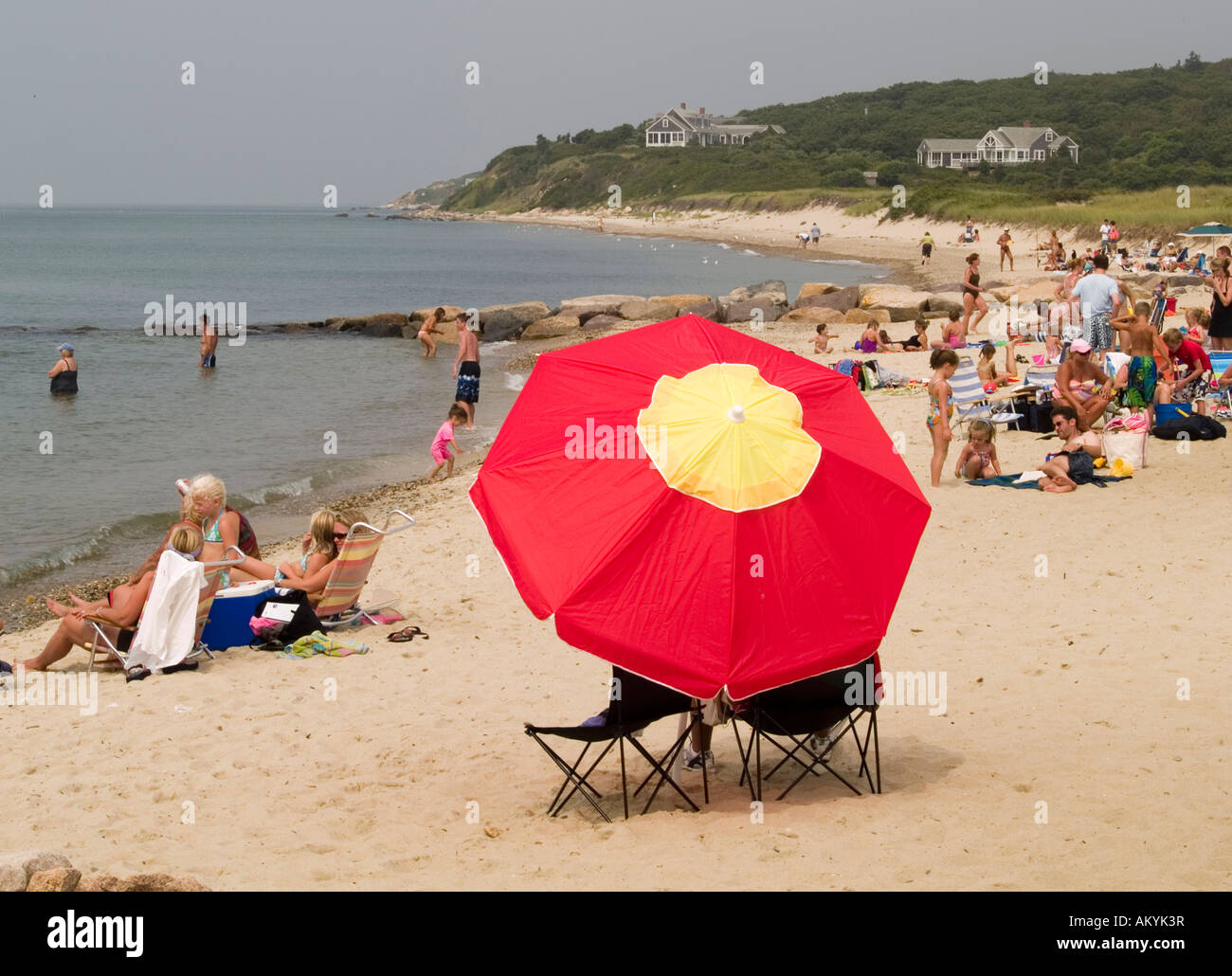 A busy beach full of people on a sunny day in the fishing village of ...
