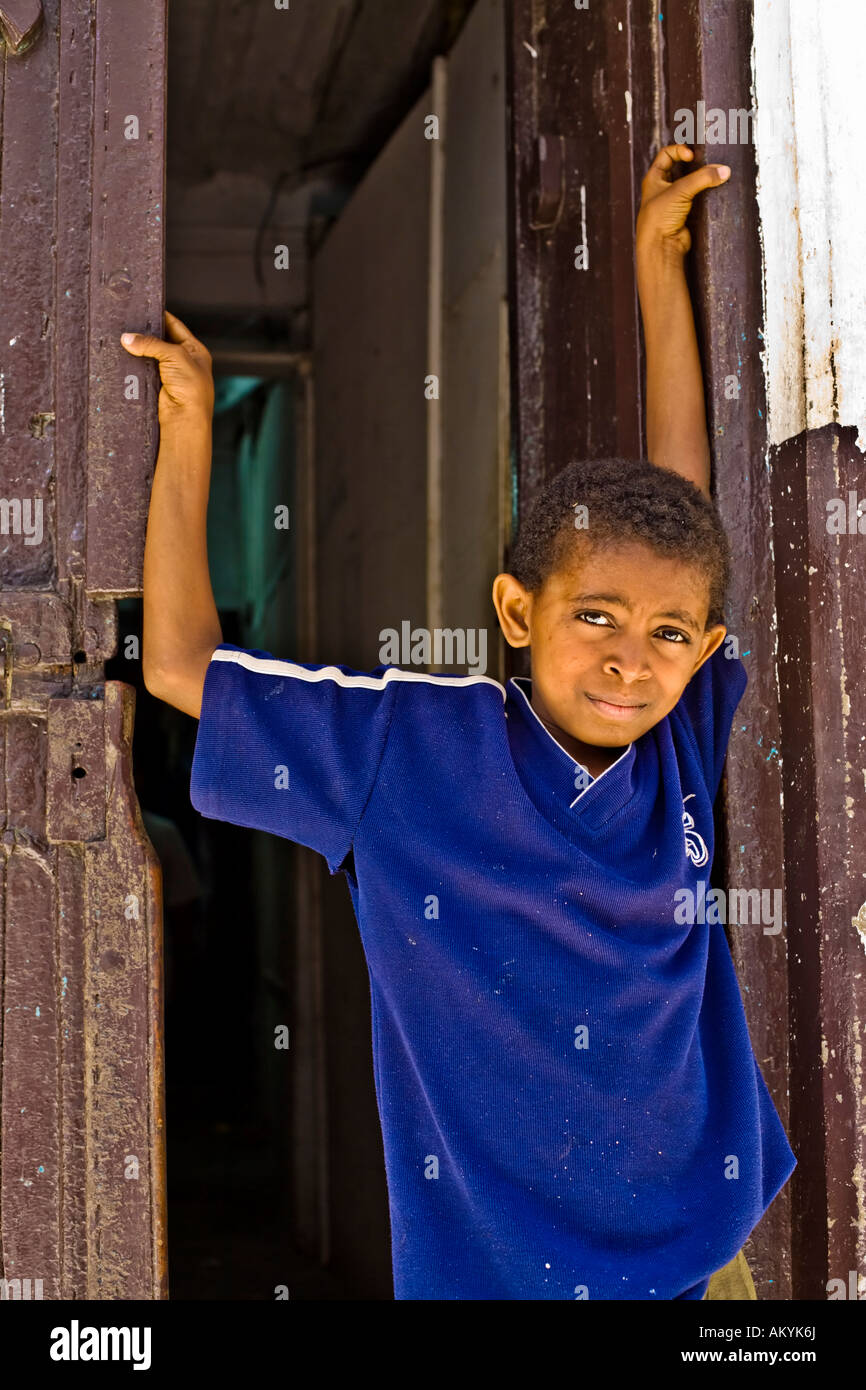 Child standing in the doorway of a house Stone Town Zanzibar Stock ...