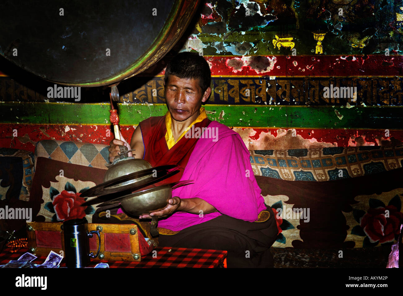 Monk with drums and cymbal at the Ganden convent (4300m) near Lhasa ...