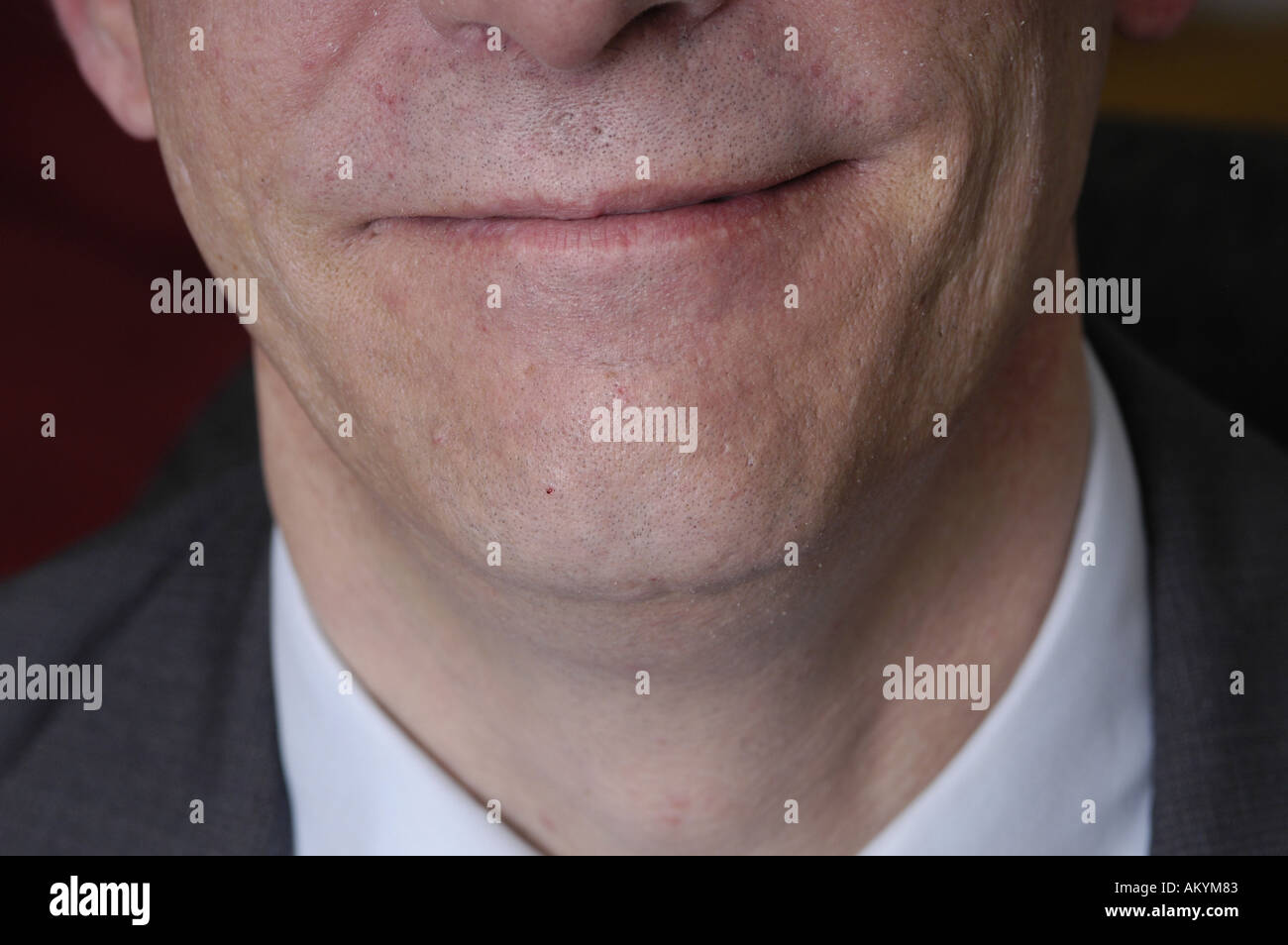 A close up of a man's lower face and neck, dressed in a suit Stock ...