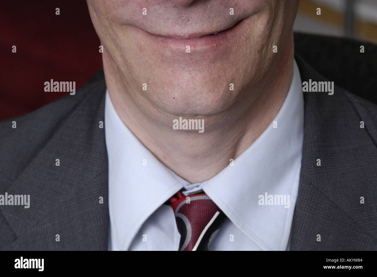 A close up of a man's lower face and neck, dressed in a suit Stock ...