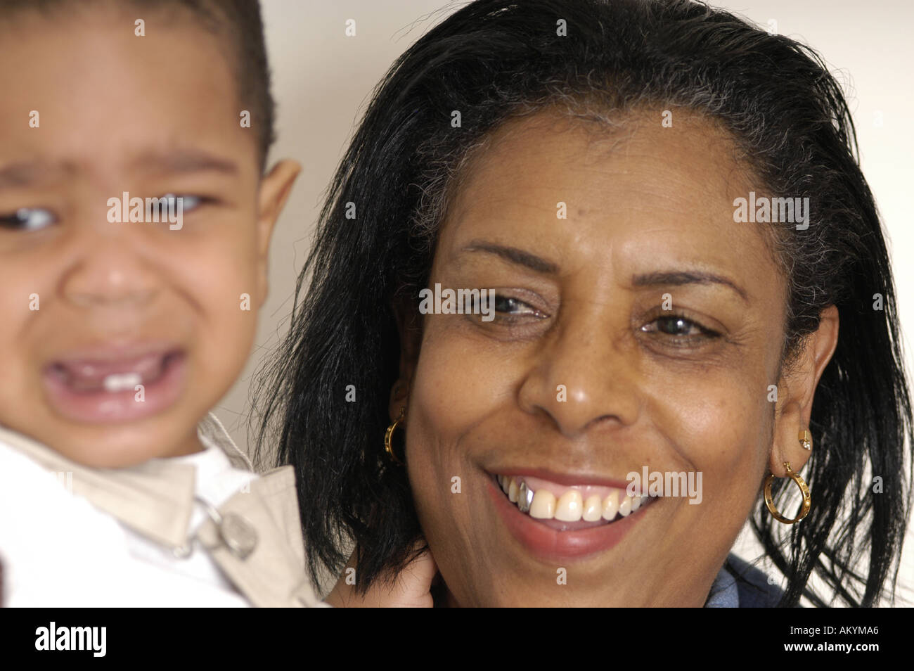 mother and child baby crying soothe cuddle hug smiling Stock Photo - Alamy