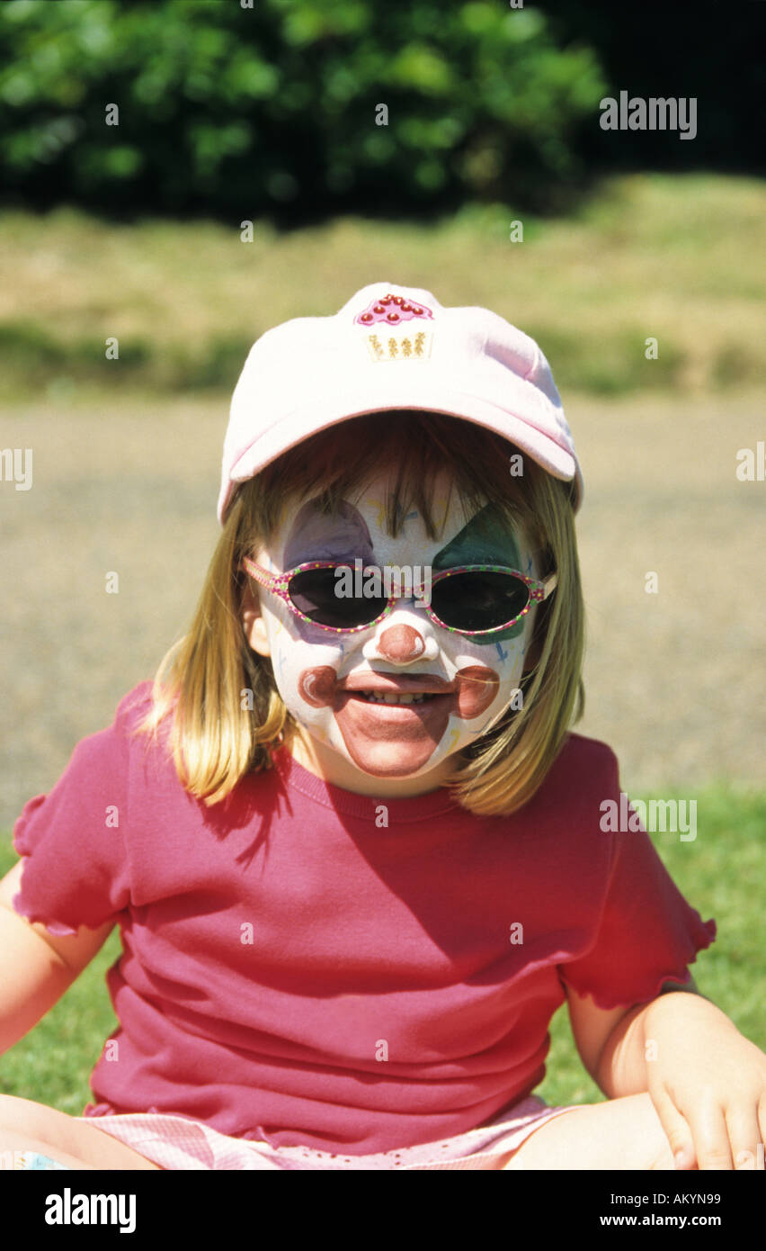 cheeky girl with her face painted to look like a clown Stock Photo - Alamy