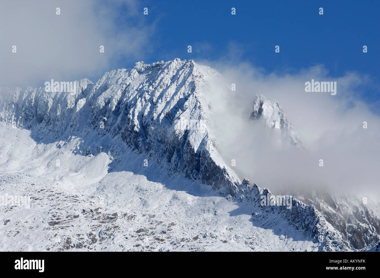 Clouds with freshly snow covered mountains in the Aletsch area, Goms ...