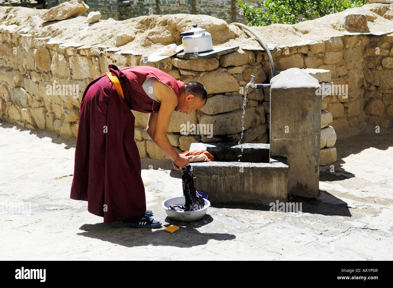 Buddhist monk washes his clothes, Drepung monastery, literally Rice ...