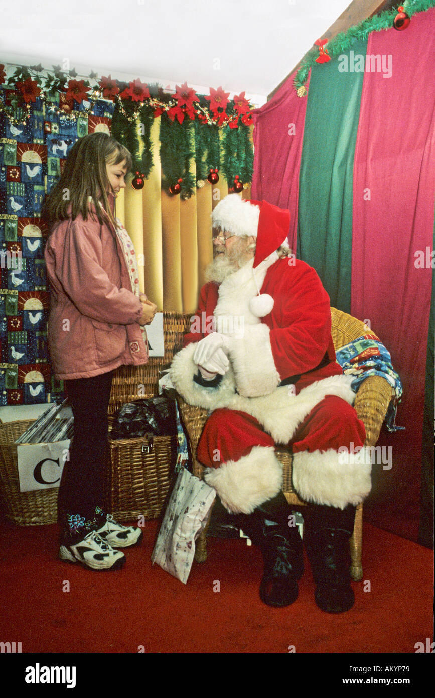 girl telling Father Christmas her present wish for Christmas Stock ...