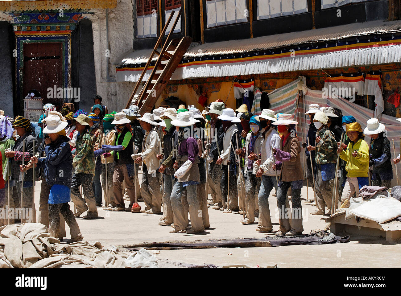 Young girls compressing new ground with their feet, Potala, Lhasa ...