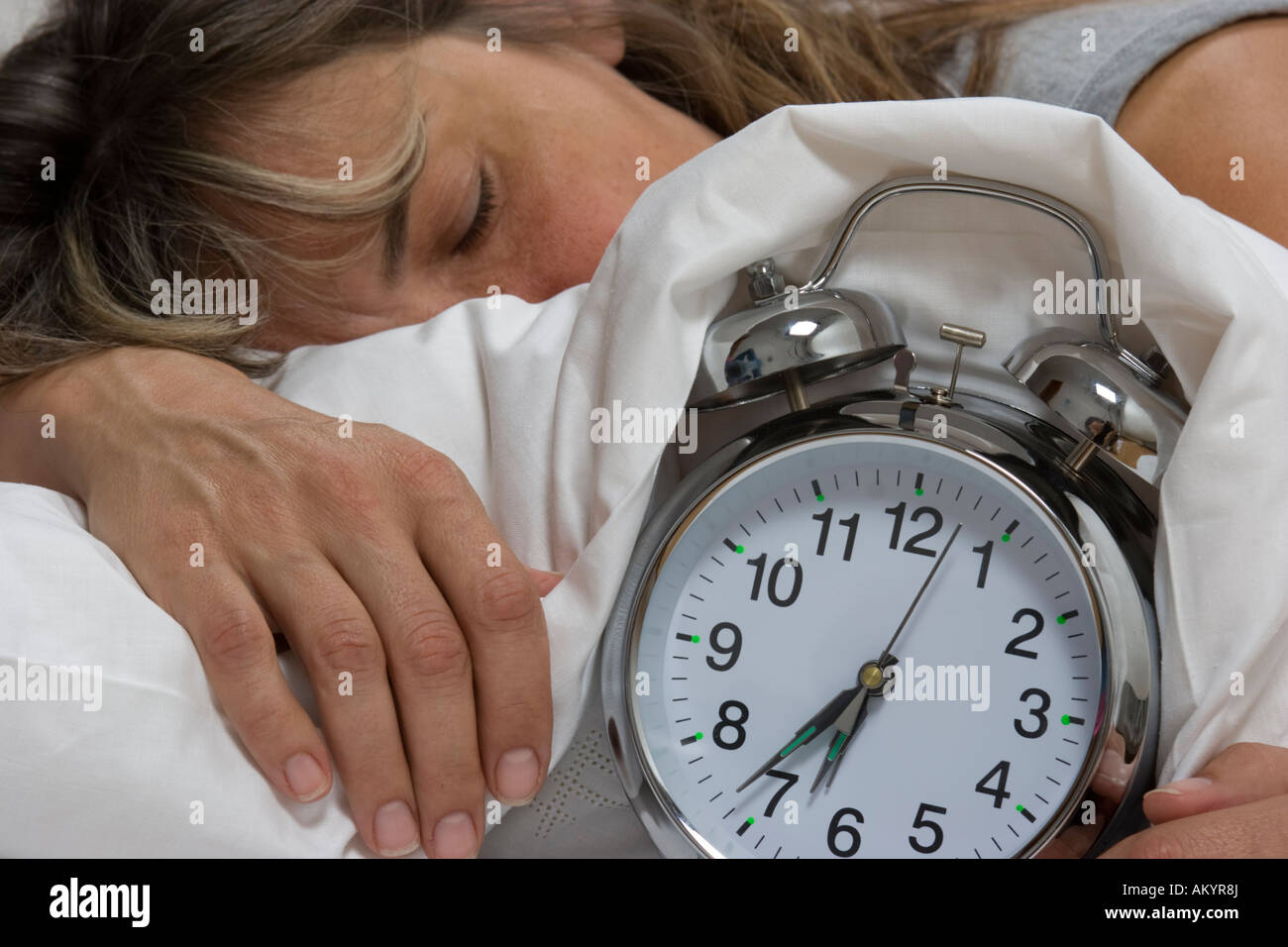 Sleeping woman, alarm clock Stock Photo - Alamy