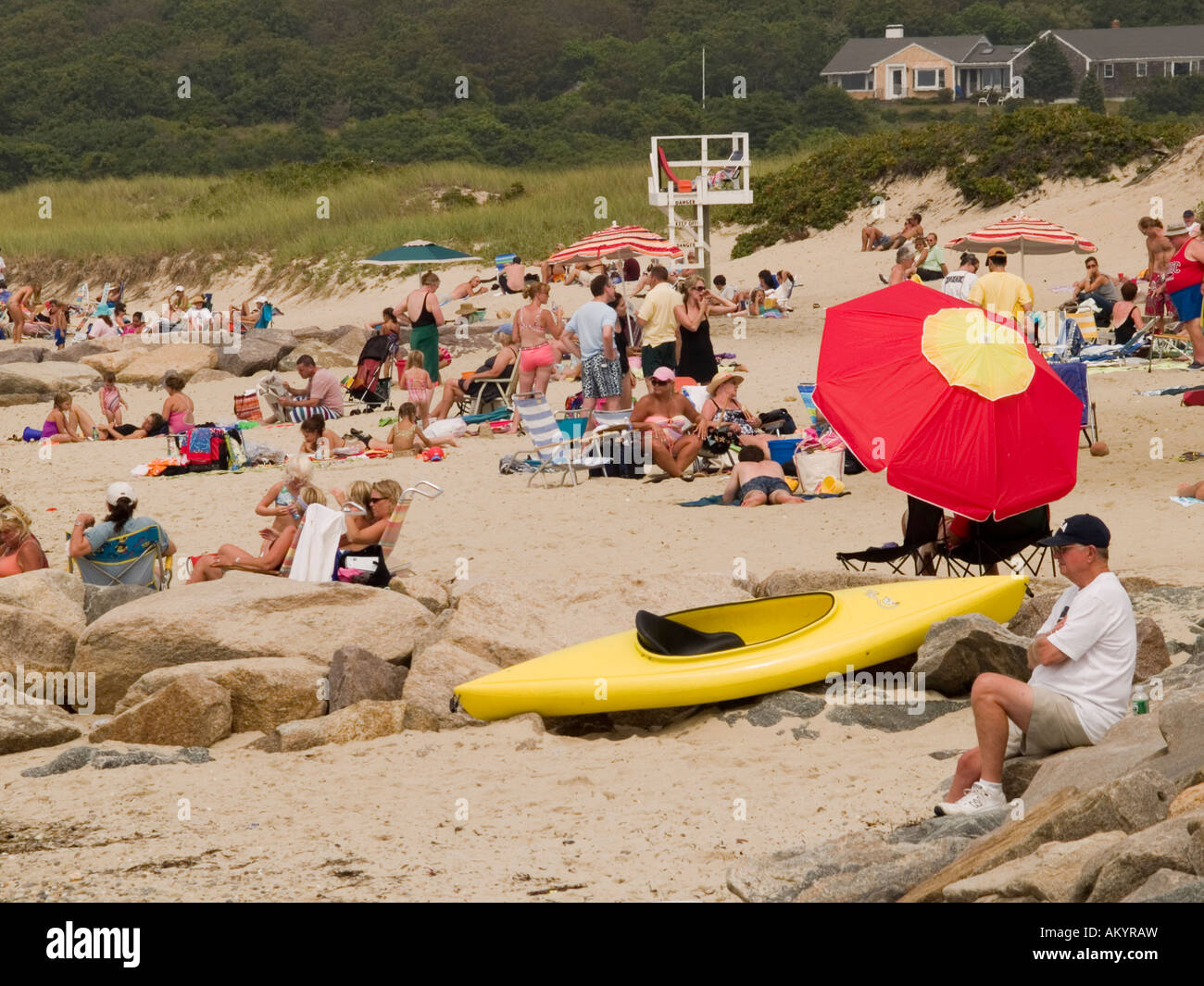 A busy beach full of people on a summer day in the fishing village of ...