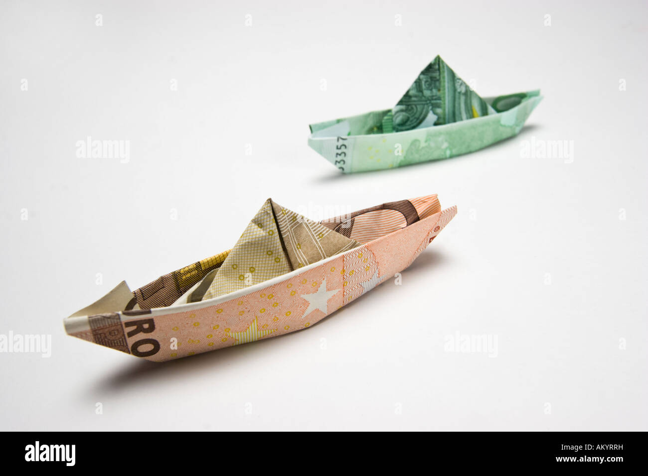 Small ships made of banknotes Stock Photo - Alamy