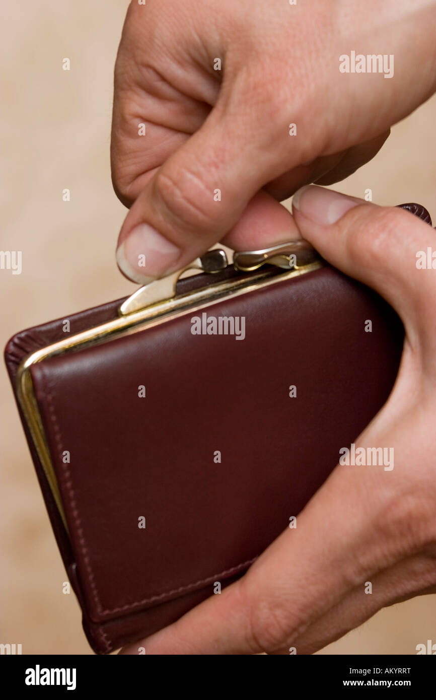 Hands opening a purse Stock Photo - Alamy