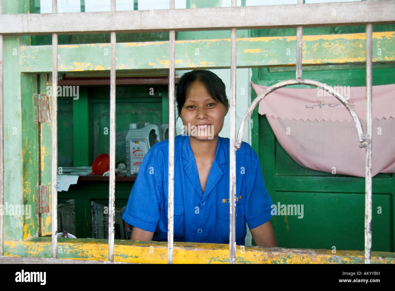 Young woman behind barred window, China Stock Photo - Alamy