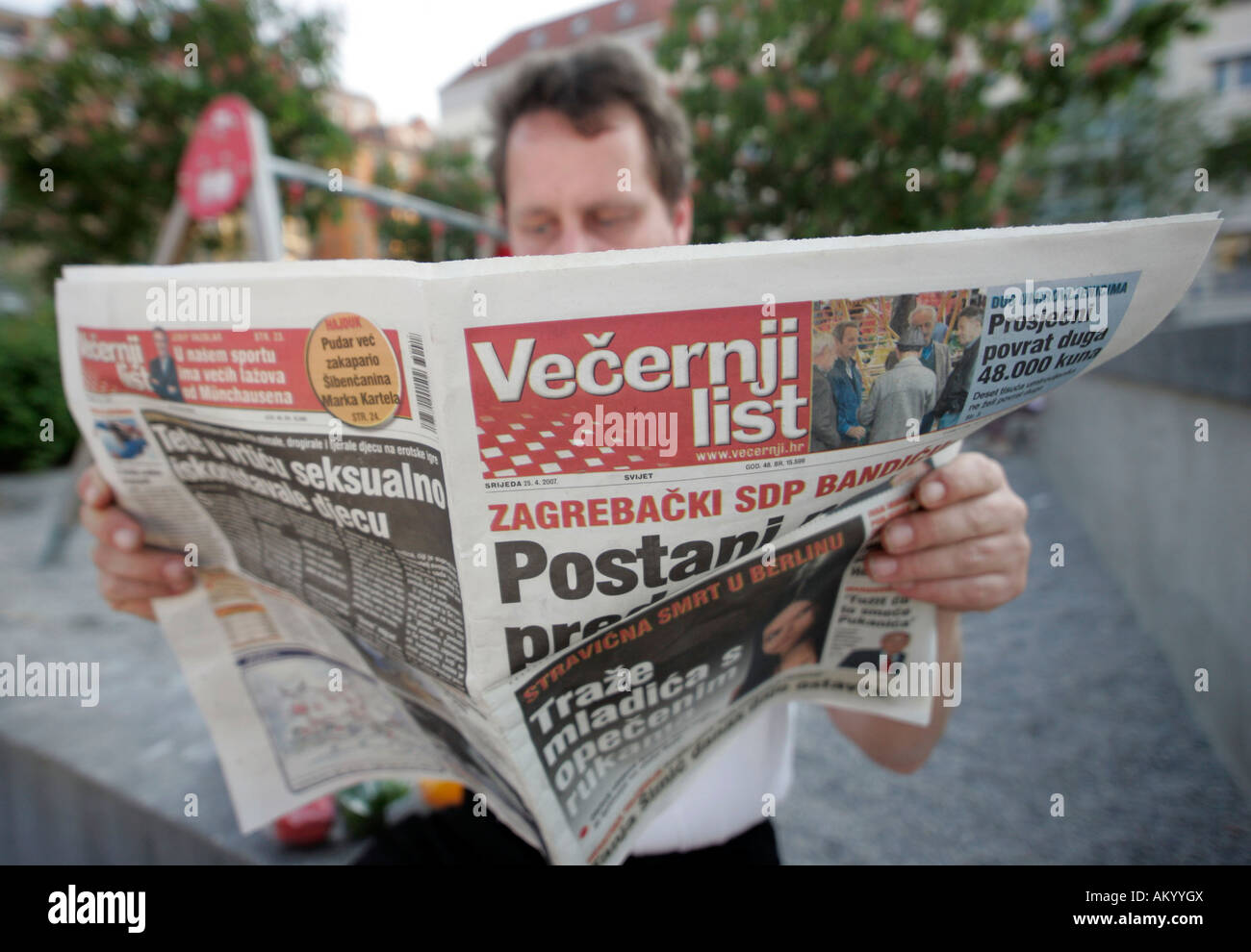 A man reading a croatian newspaper that is published in Germany Stock ...
