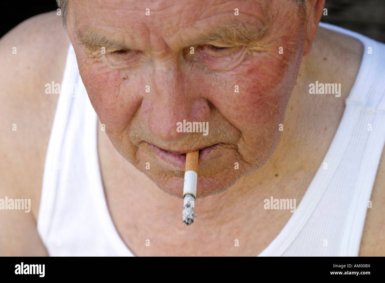 Smoking old man Stock Photo - Alamy