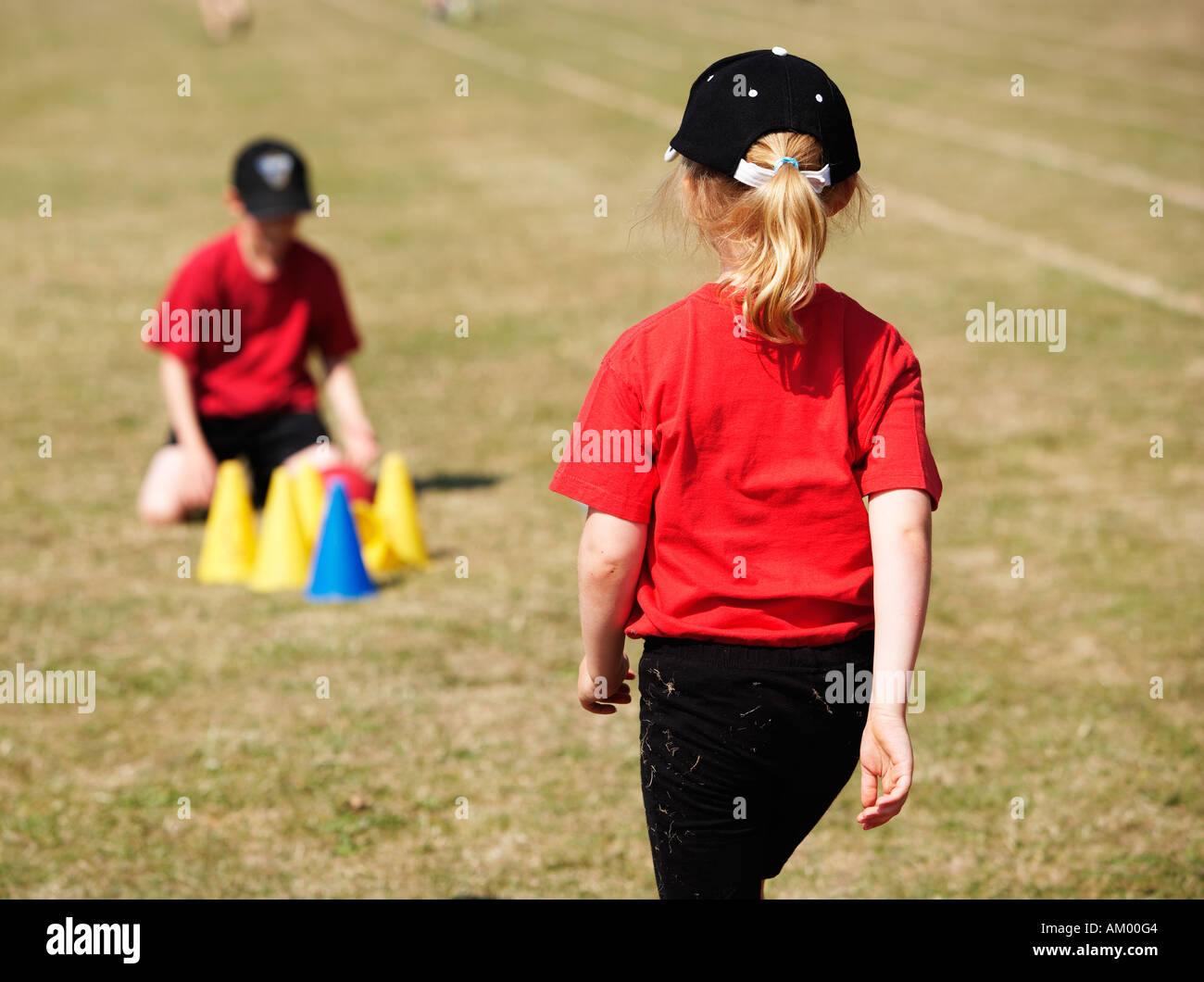 Young six year old girl participating in summer sports day at her ...