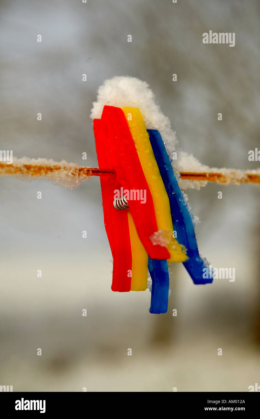 Humorous Cold washing line pegs in the winter snow showing Stock Photo ...