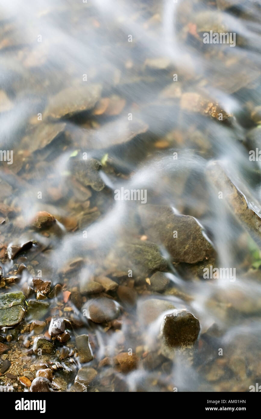 Water flowing around the rocks and pebbles of Bowden Burn, Scottish ...