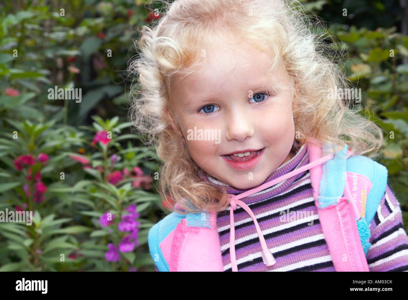 mischievous mistrustful little girl in ornamental garden Stock Photo ...