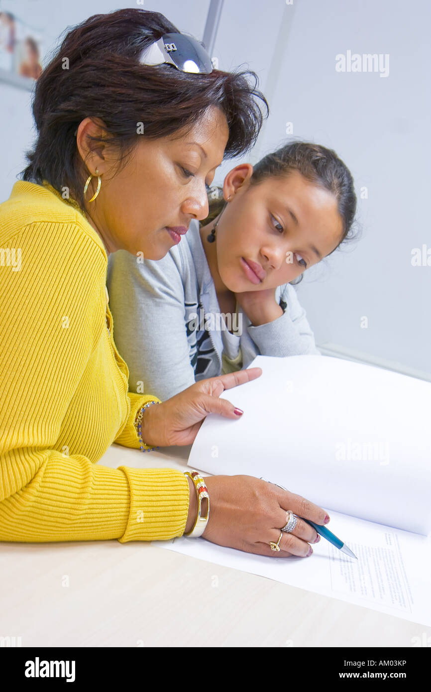 Mother signing a contract on behalf of her daughter Stock Photo - Alamy