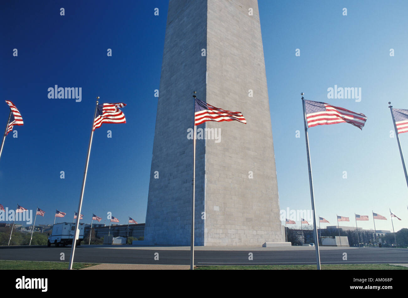 An early morning breeze stirs the American flags surrounding the ...