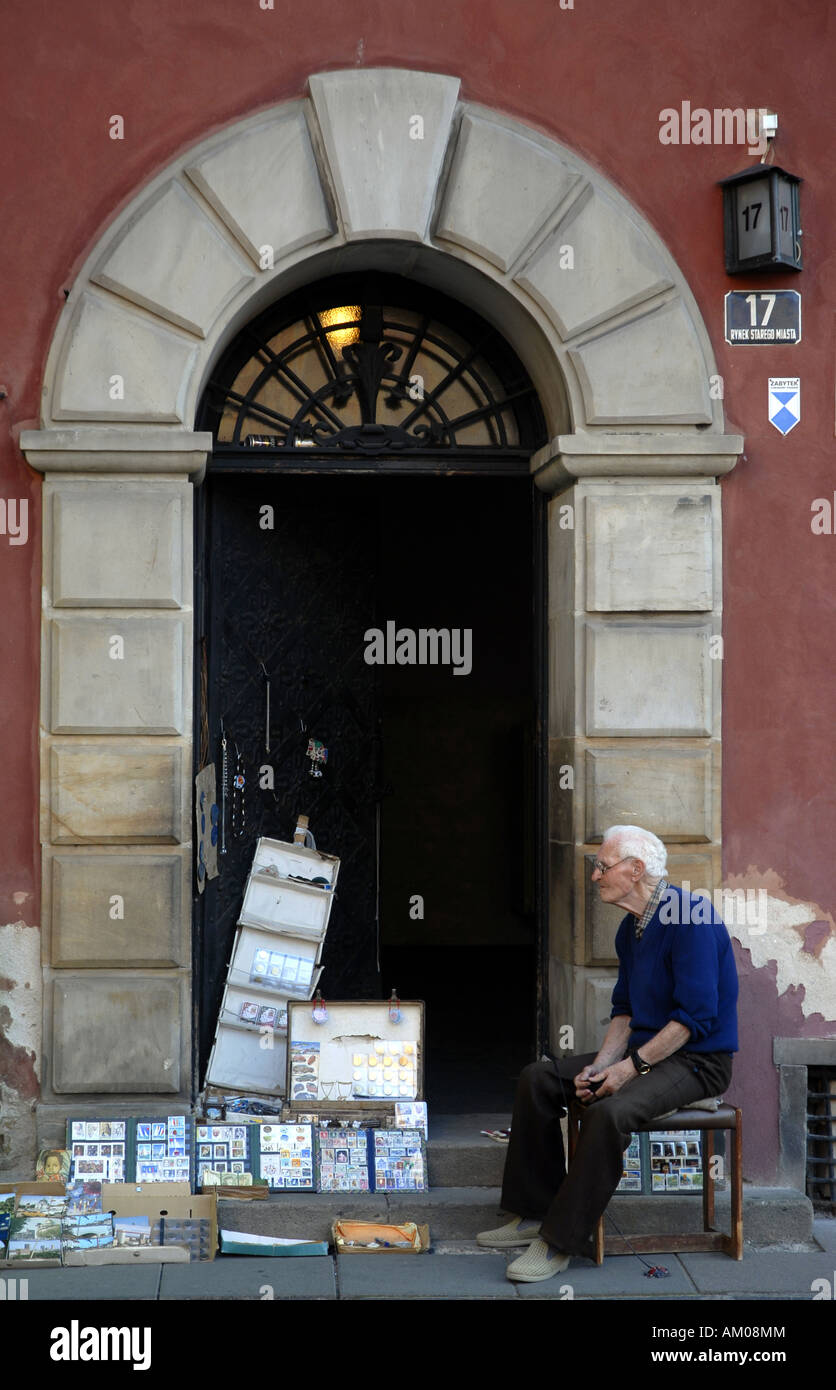 An old man sells stamps in a doorway on the Old Town Market Square ...