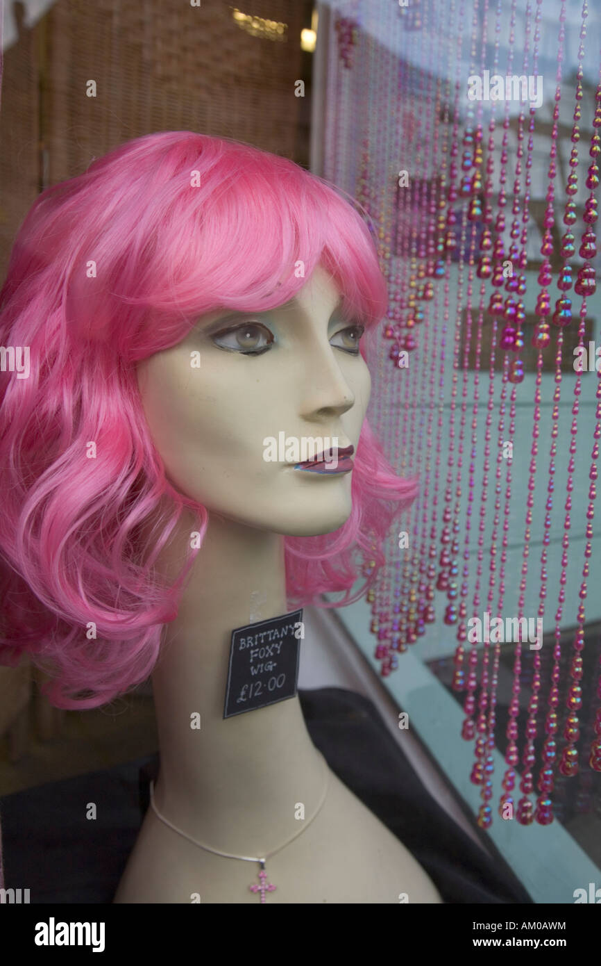 Pink wig in shop window Wells Somerset England Stock Photo - Alamy