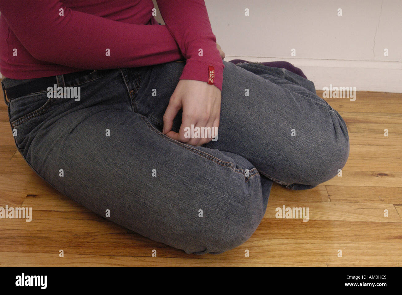 jeans sitting rest recline relax sit pose posture Stock Photo - Alamy