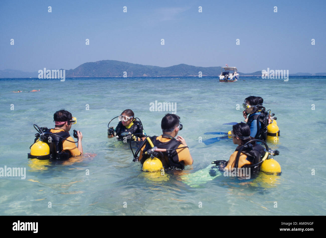 THAILAND Phuket Coral Island Koh Hi Beach Tourists having scuba diving ...