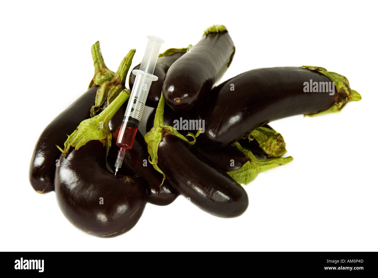 syringe in a aubergines eggplants gm ogm food genetic modificarion ...