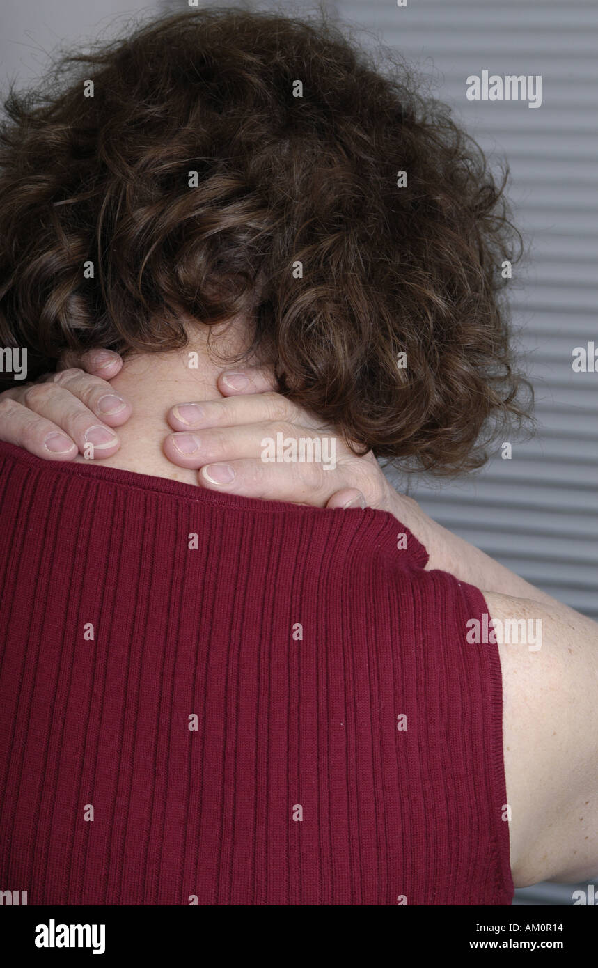 A woman messaging a sore spot on her body Stock Photo - Alamy