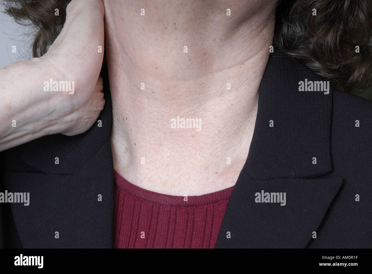 A woman messaging a sore spot on her body Stock Photo - Alamy