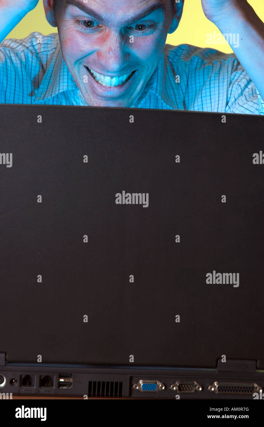 Computer user having a bad day with tech problems online. His face ...