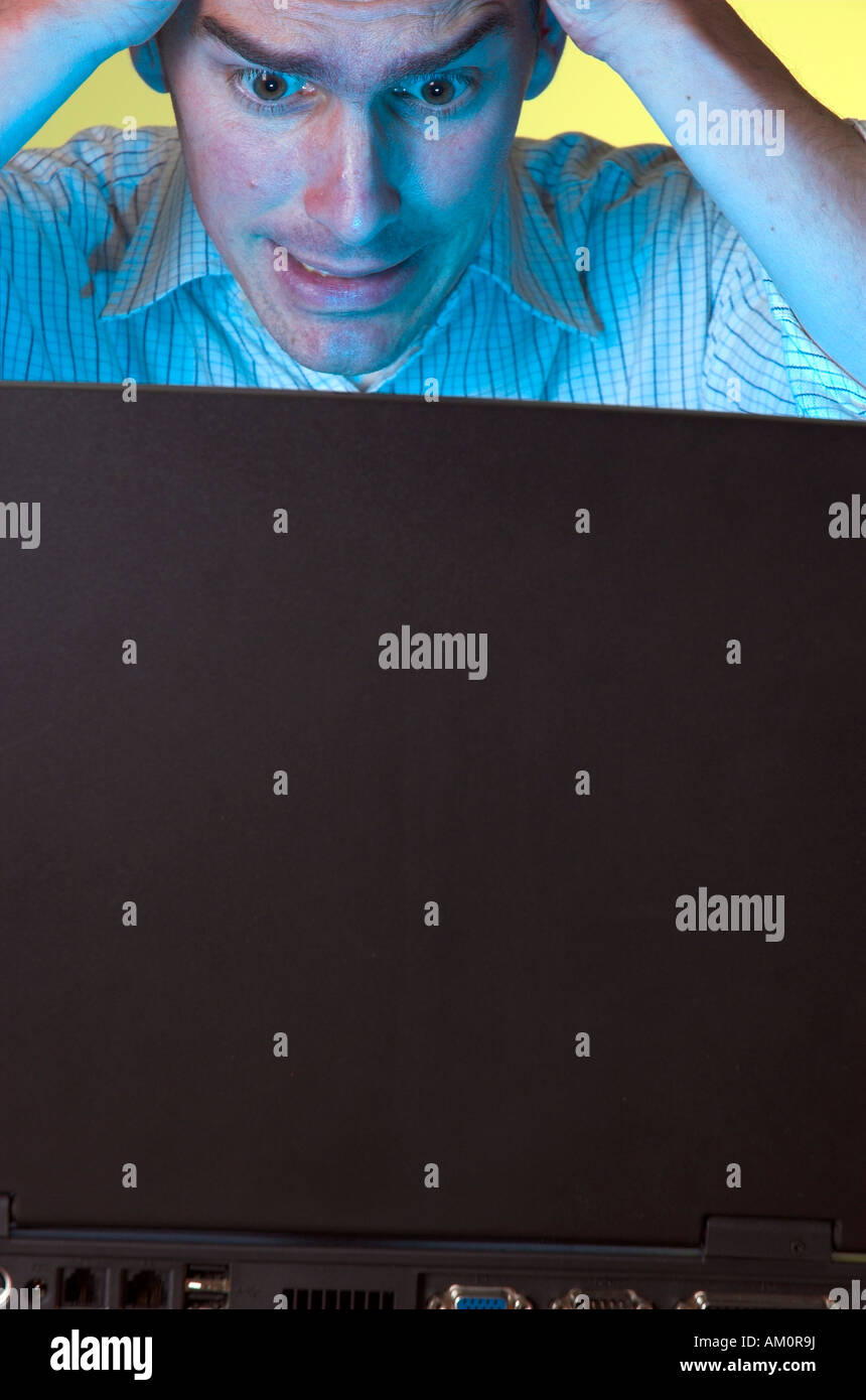 Computer user having a bad day with tech problems online. His face ...