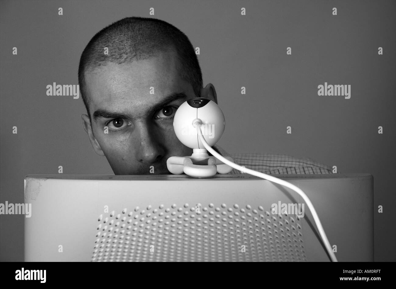 A young male computer user sitting in front of an Internet webcam Stock ...