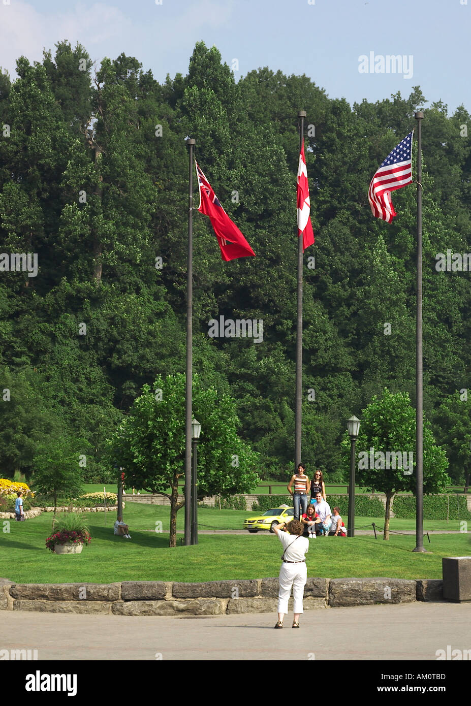 Woman taking photos of her family standing under a flag hi-res stock ...