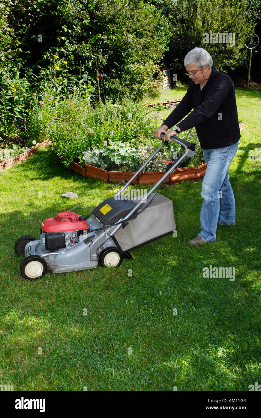 Man mowing lawn Stock Photo - Alamy