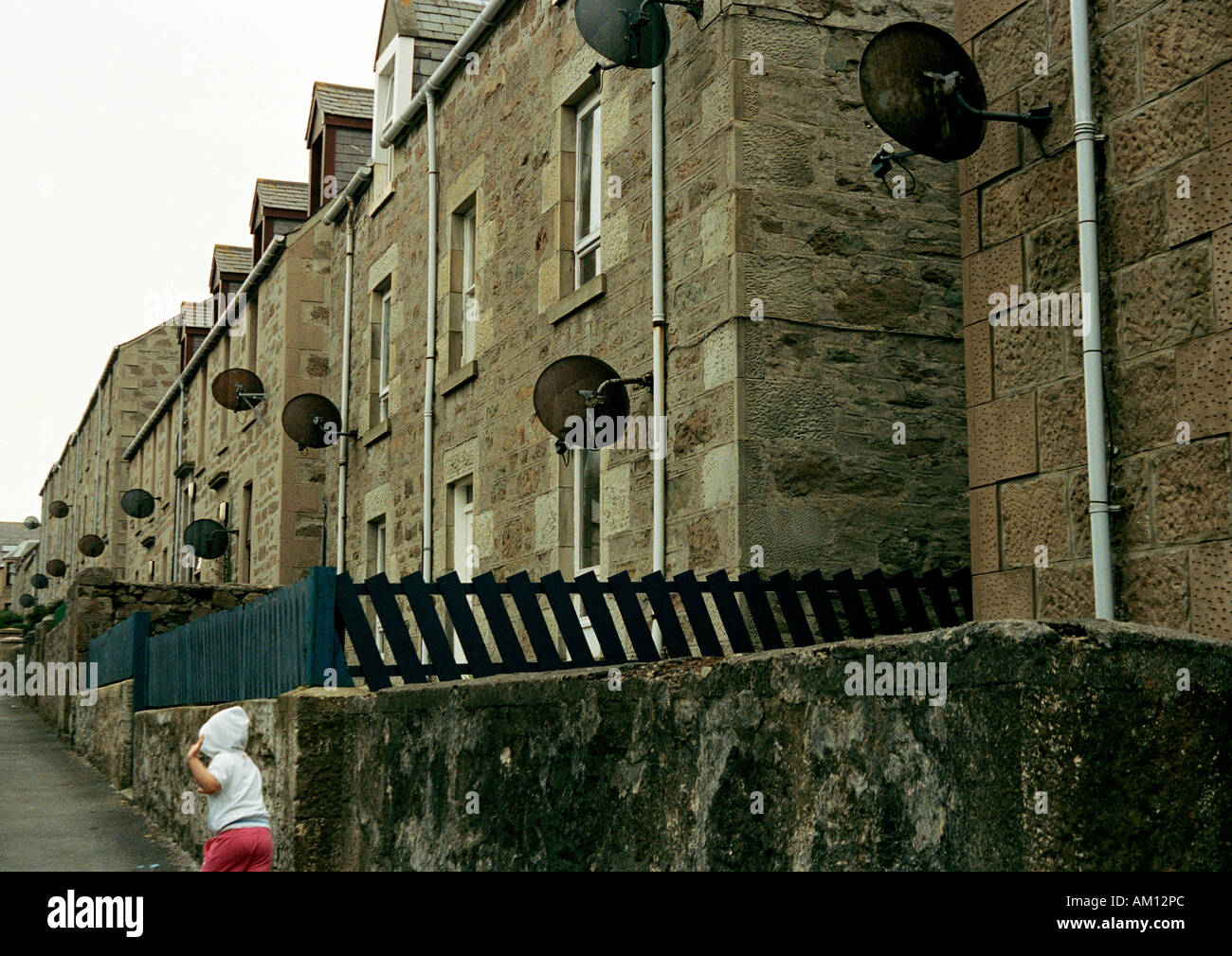 Young girl running down a street in Lerwick, The Shetland Isles ...