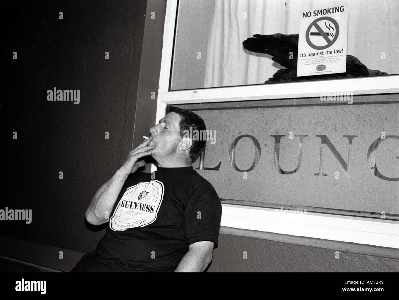Man smoking outside a pub in Ireland soon after the introduction of the ...