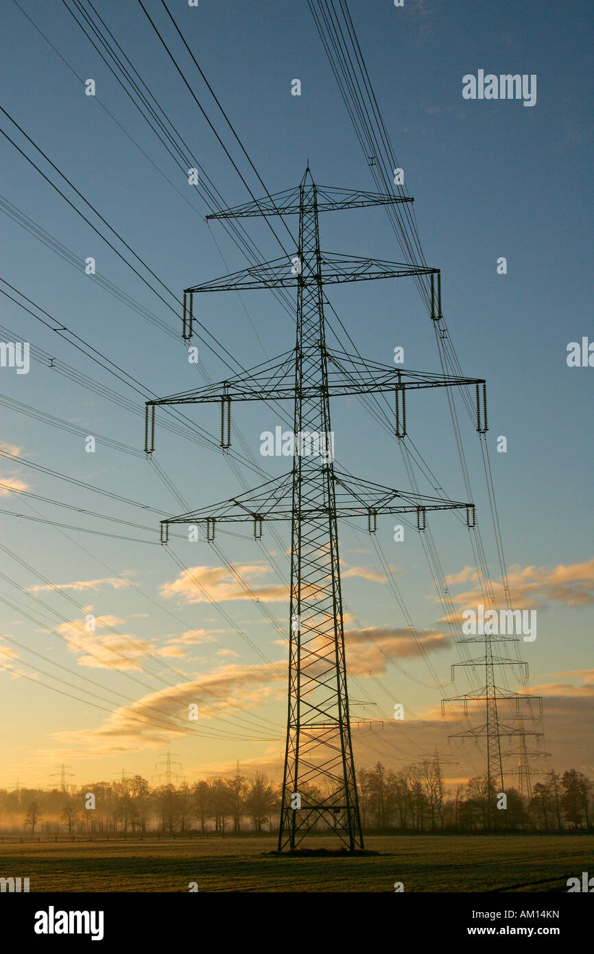 Power poles - high voltage electrical power lines - sunrise at winter ...