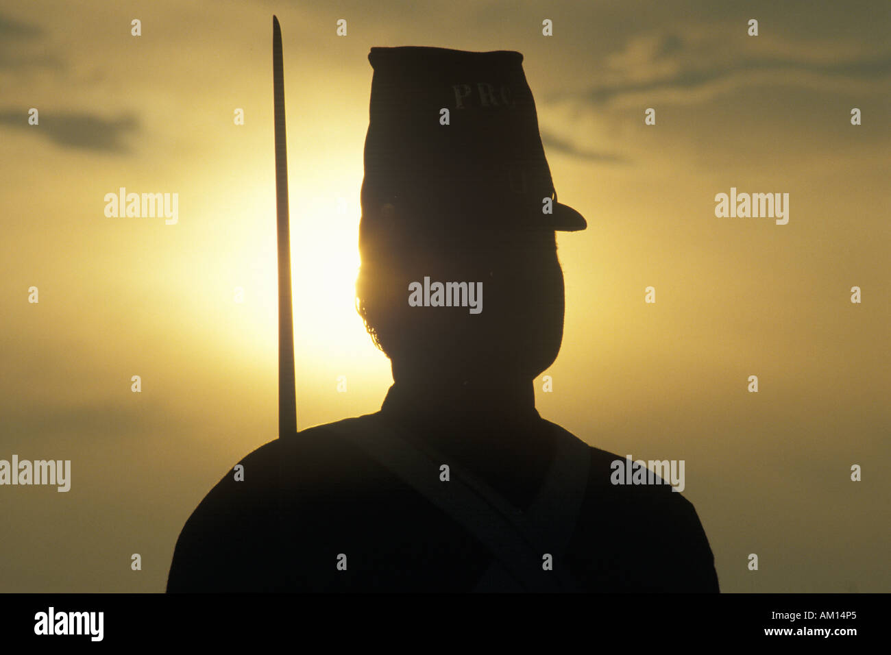 Silhouette of soldier at sunset with gun during reenactment of Battle ...