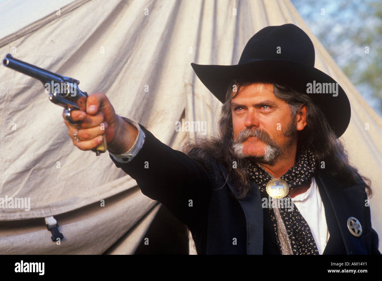 Living History participant posing as US Marshall pointing gun CA Stock ...