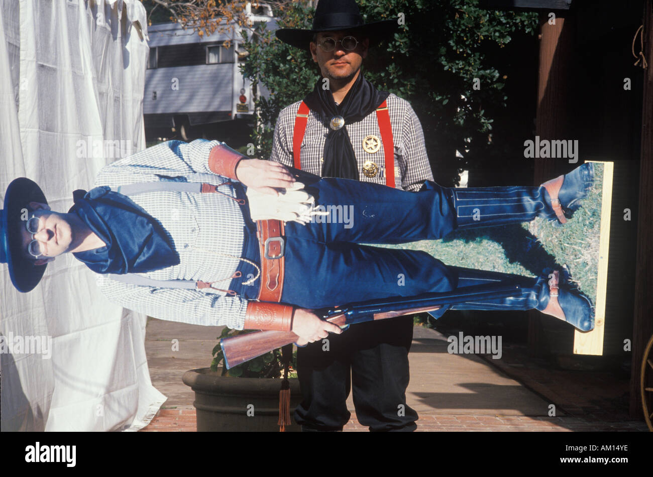 Cowboy in full costume with cardboard cutout Stock Photo - Alamy