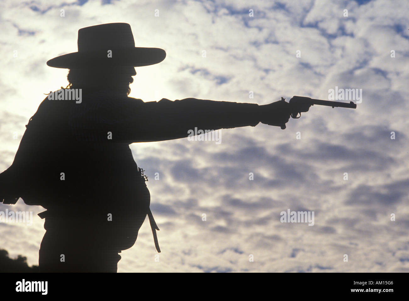 Silhouette of Cowboy aiming pistol Stock Photo - Alamy
