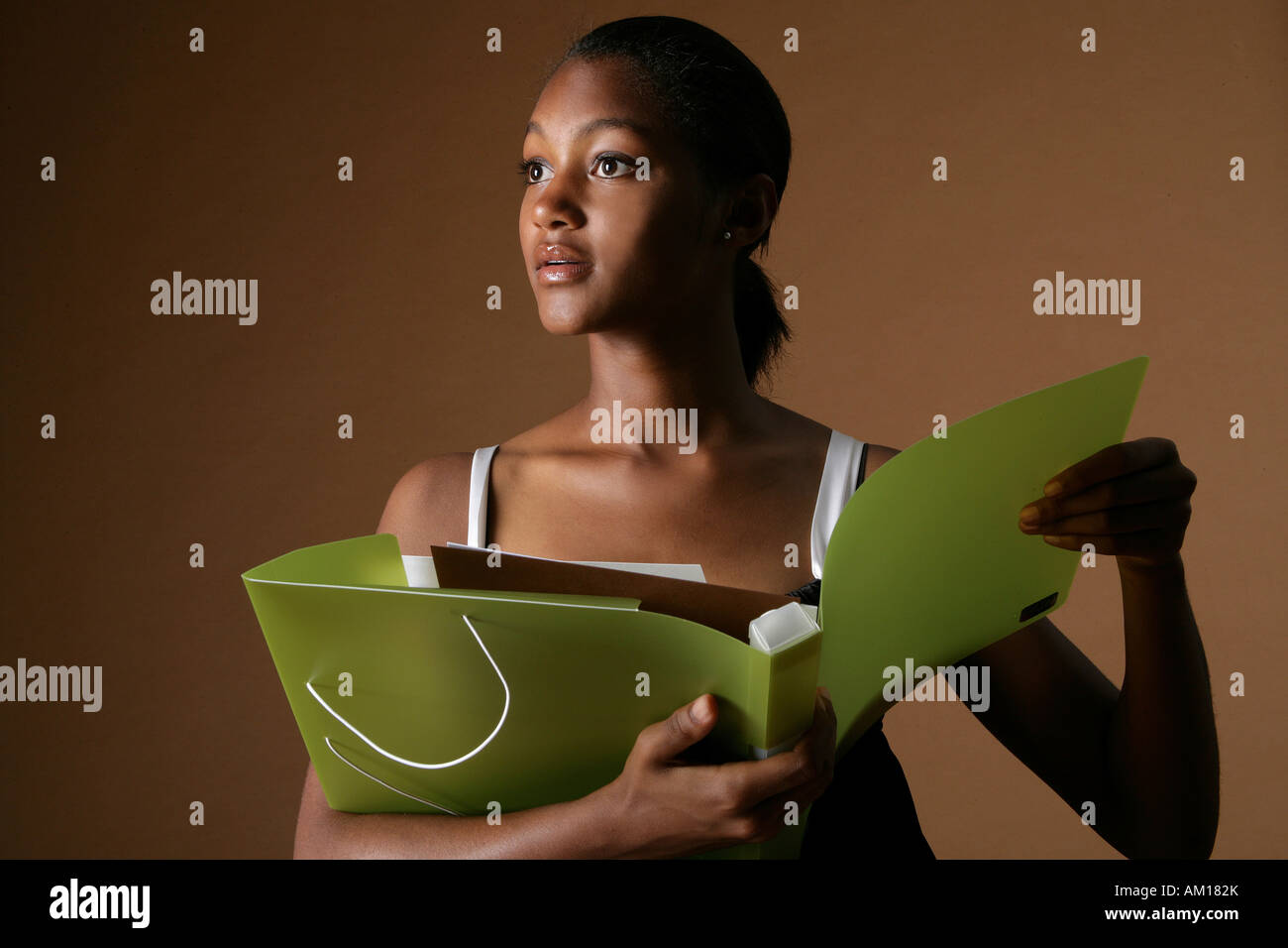 Young dark-skinned woman flicking through files Stock Photo - Alamy