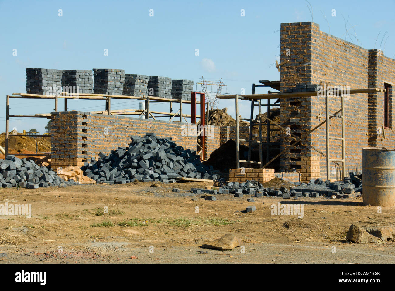 Construction site with stack of bricks and building a boundary wall ...