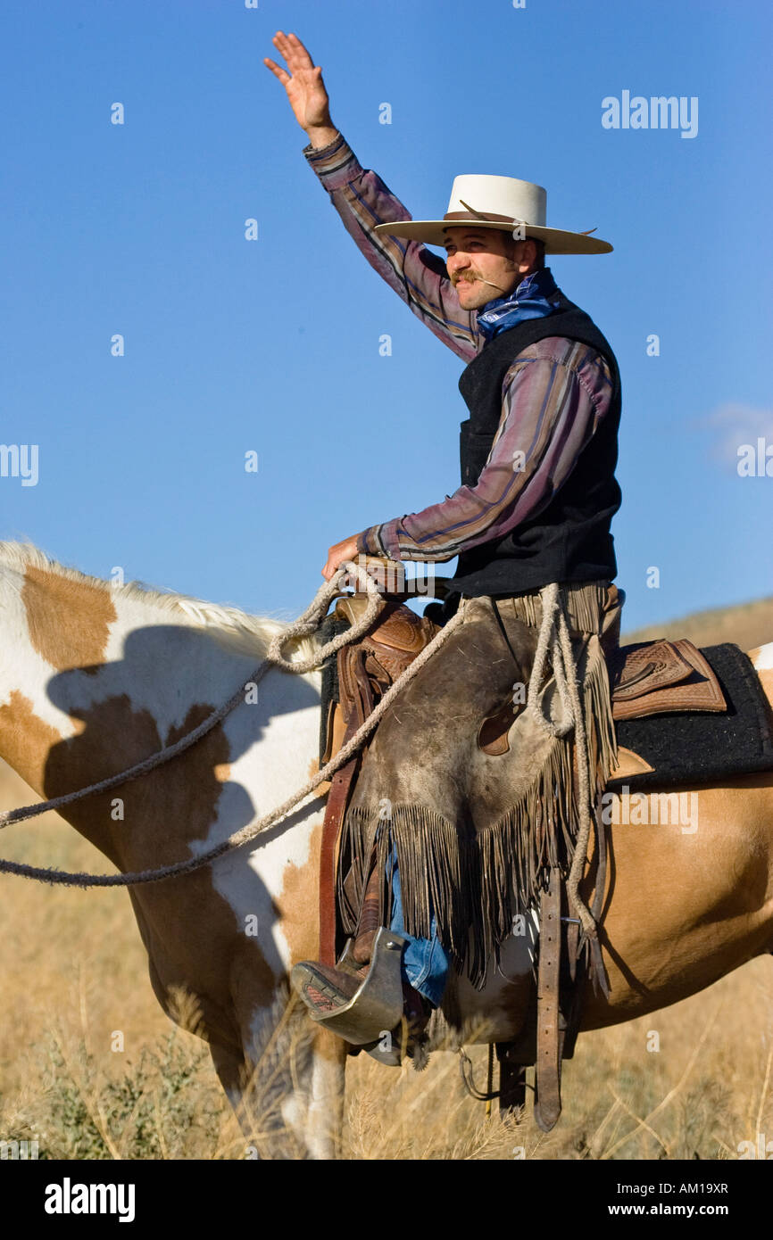 Cowboy sitting on horseback greeting, wildwest, Oregon, USA Stock Photo ...